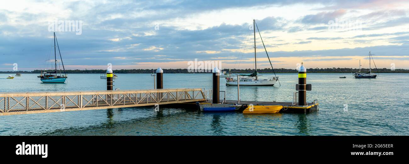 Kayaks tied to boating pontoon at dawn, Burrum River, Bururm Heads ...