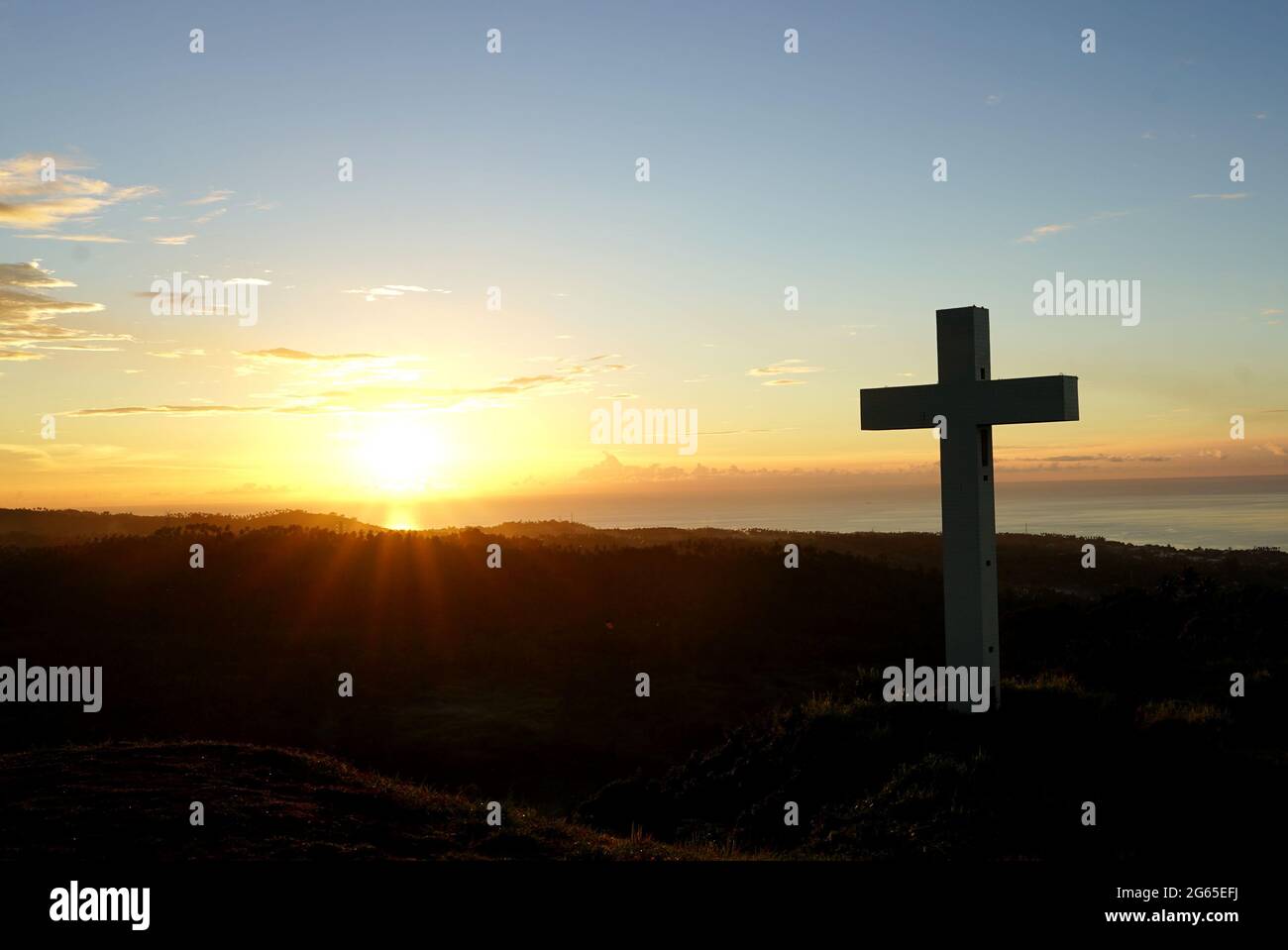 A Cross places at the hill on sunset time Stock Photo - Alamy