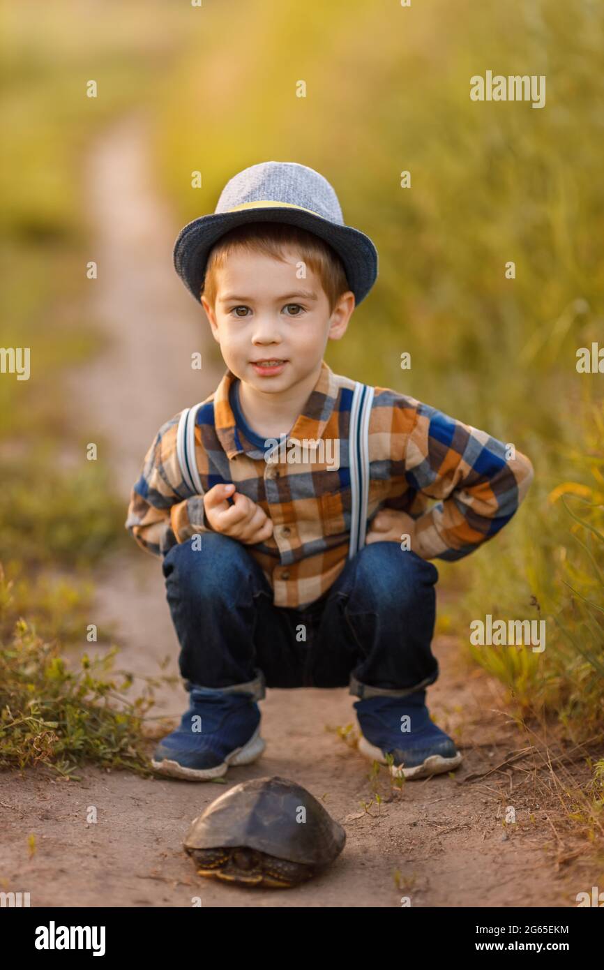 little boy exploring nature in the meadow Stock Photo - Alamy