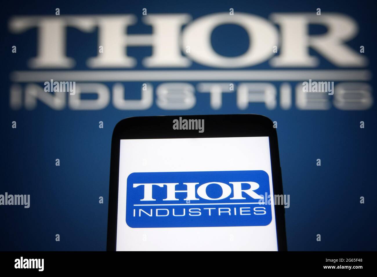 In this photo illustration a Thor Industries logo is seen on a ...