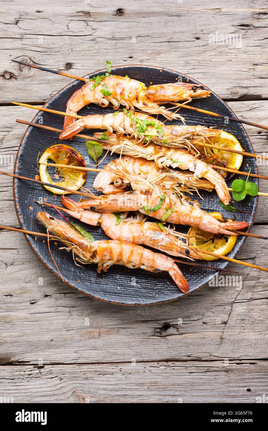 Grilled langoustines,prawn roasted on a skewer.Grilled seafood plate on ...
