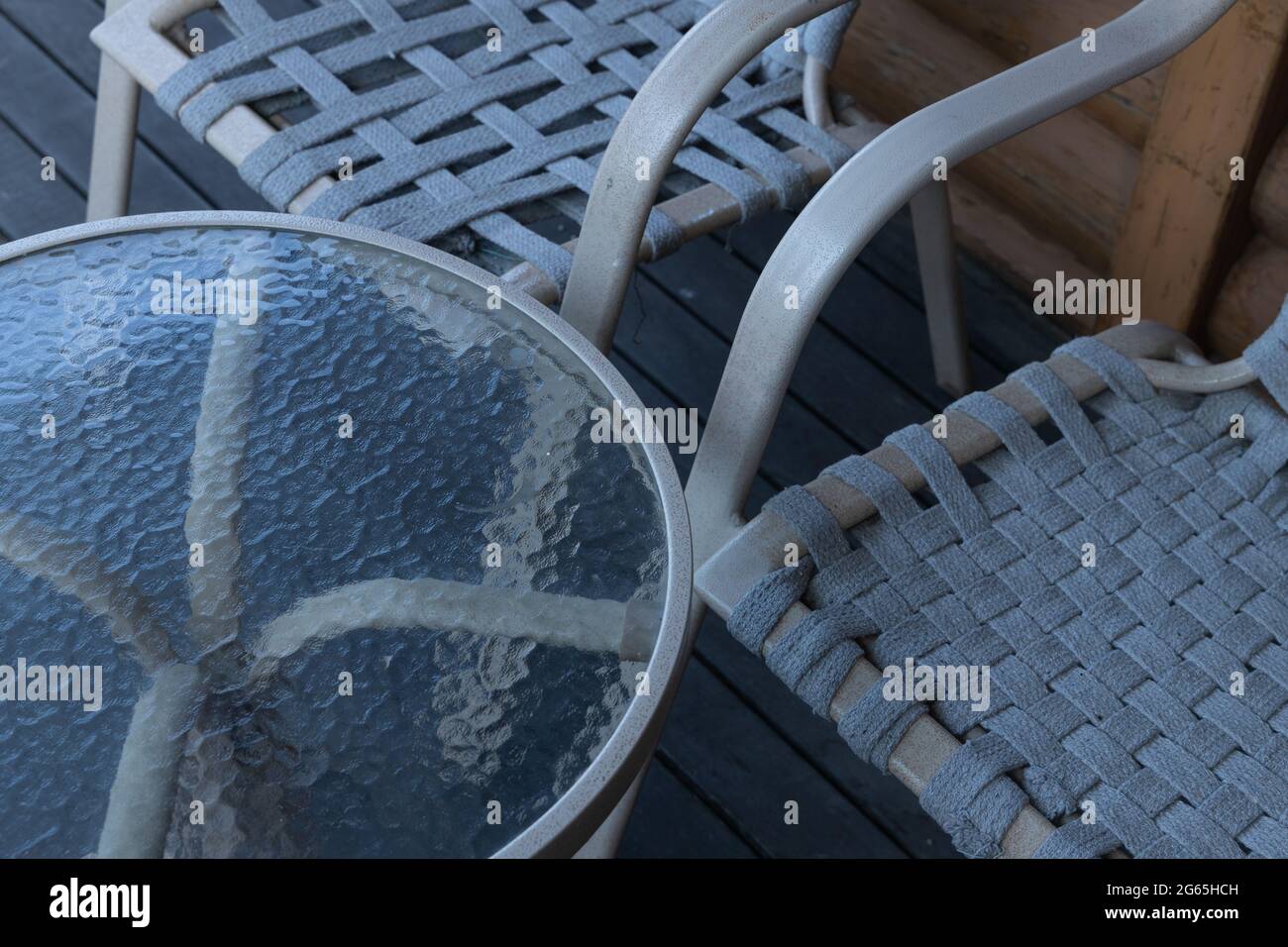 Abstract Selective focus image of a glass table and chairs depicting ...
