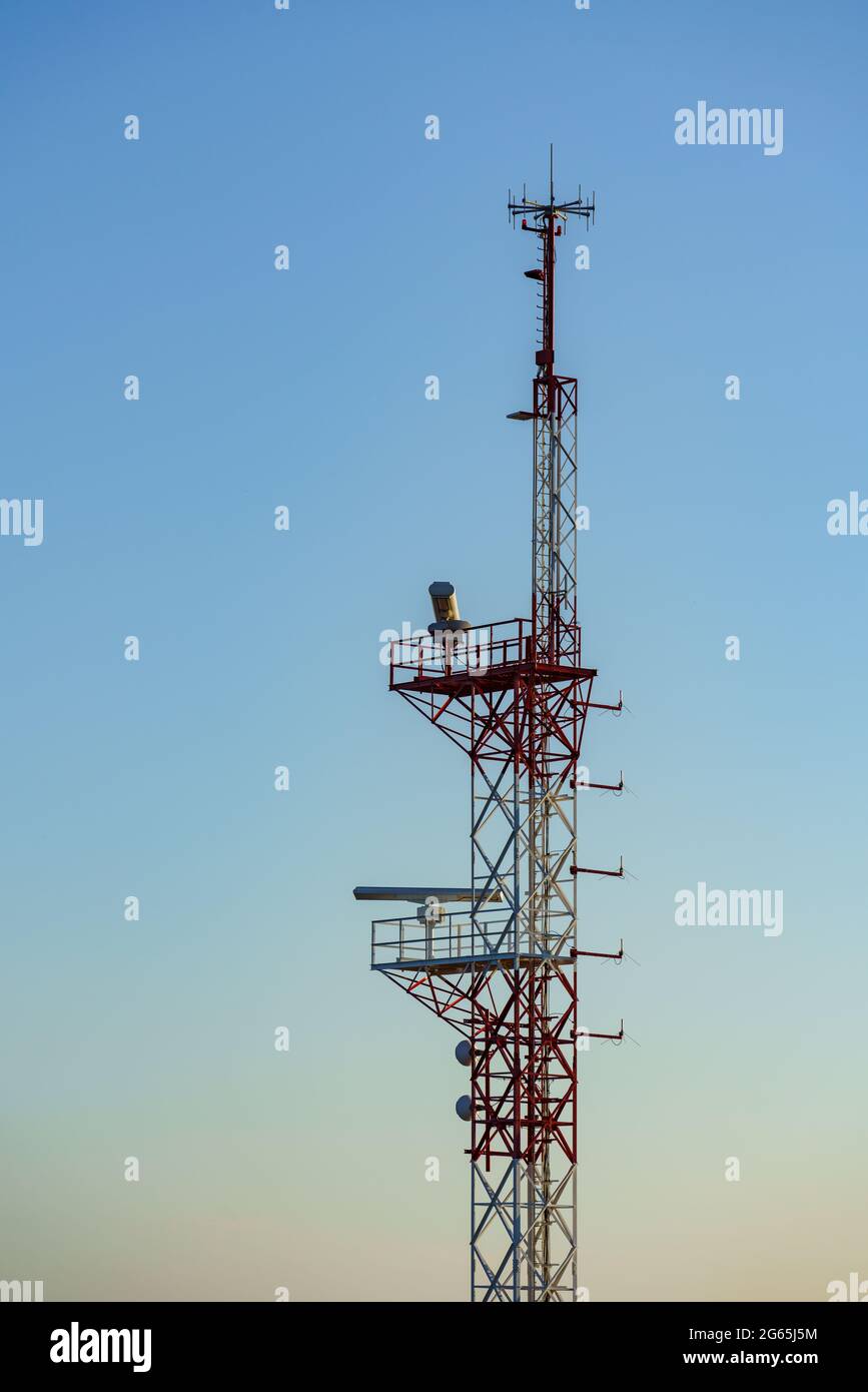 Tower painted in red and white aeronautical safety colors and a ...