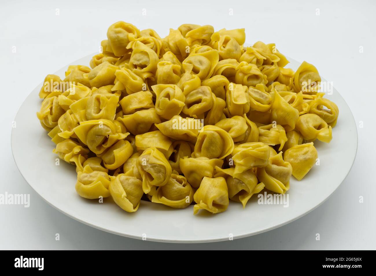 Traditional Italian Raw Tortellini in a dish, isolated on White ...