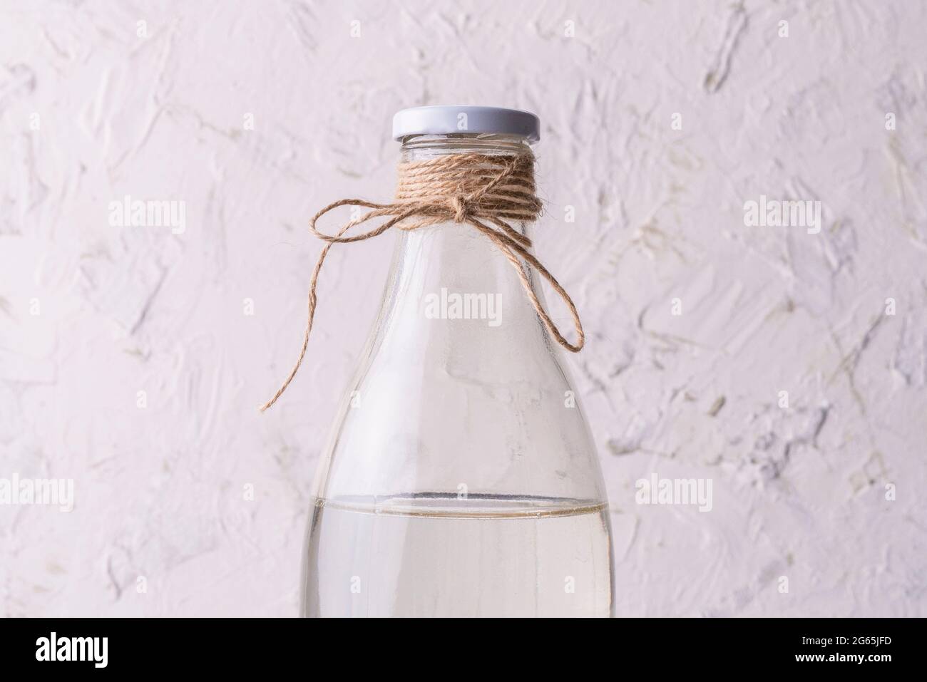 glass bottle with absolutely clean distilled water isolated on grunge ...