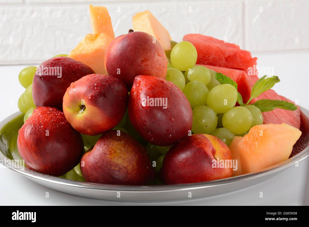 Fruit mix. Nectarine, grapes, watermelon, melon. Pieces of fruit on a ...