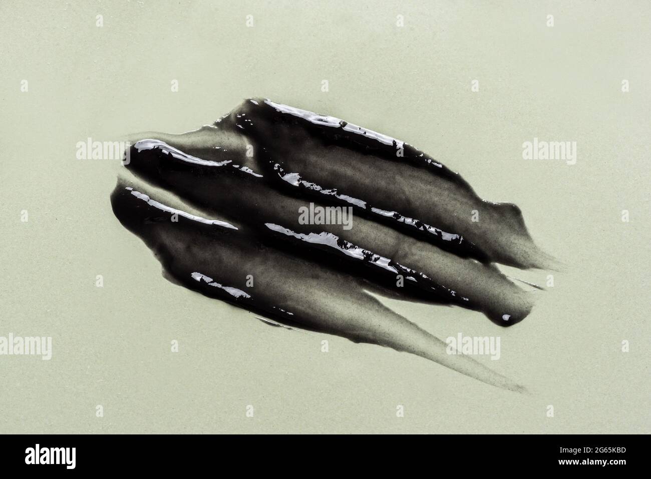 Black cosmetic gel sample on beige background. Black charcoal mask ...