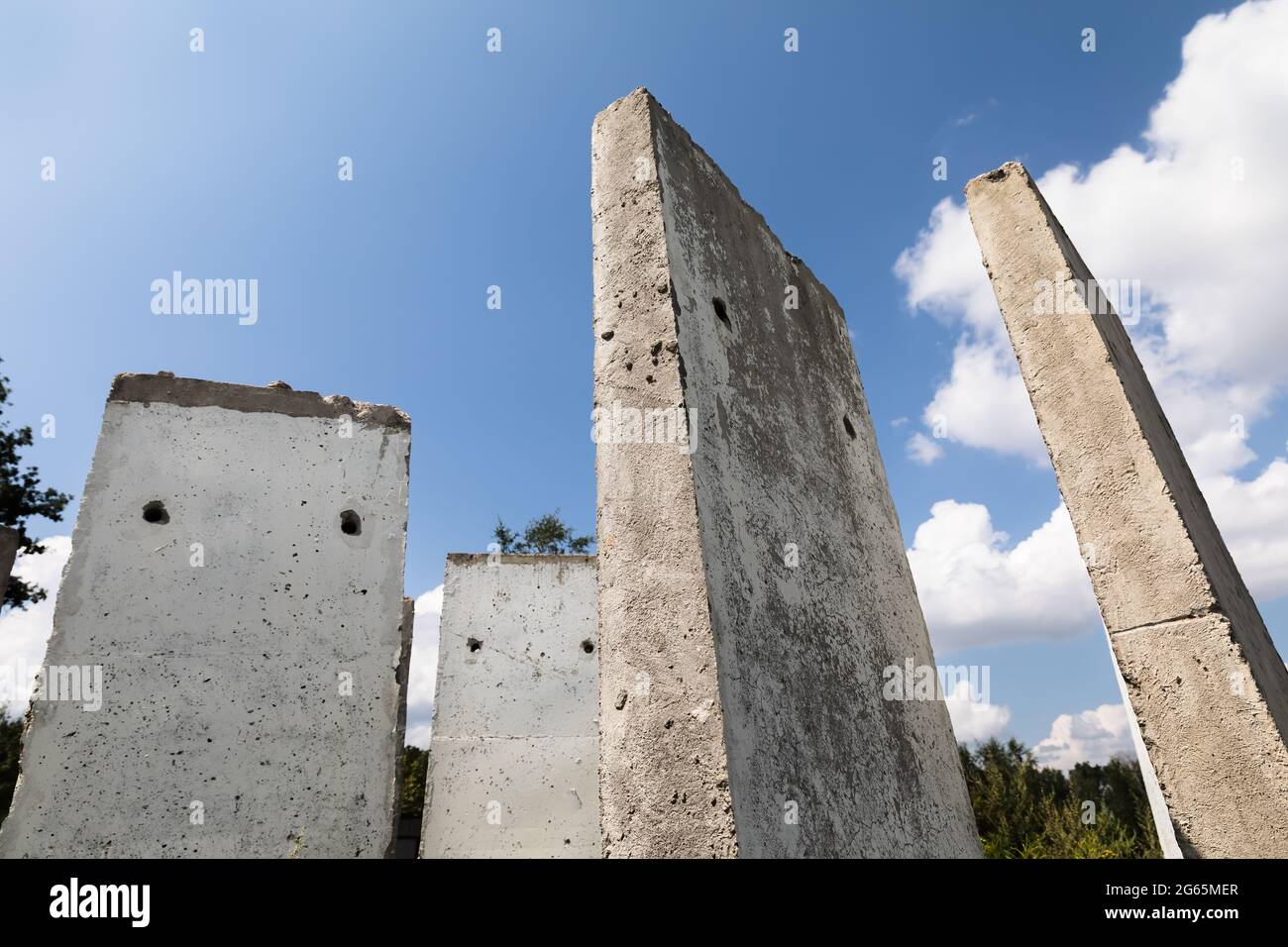 Old concrete slabs standing on a summer sunny day in the field. Old ...
