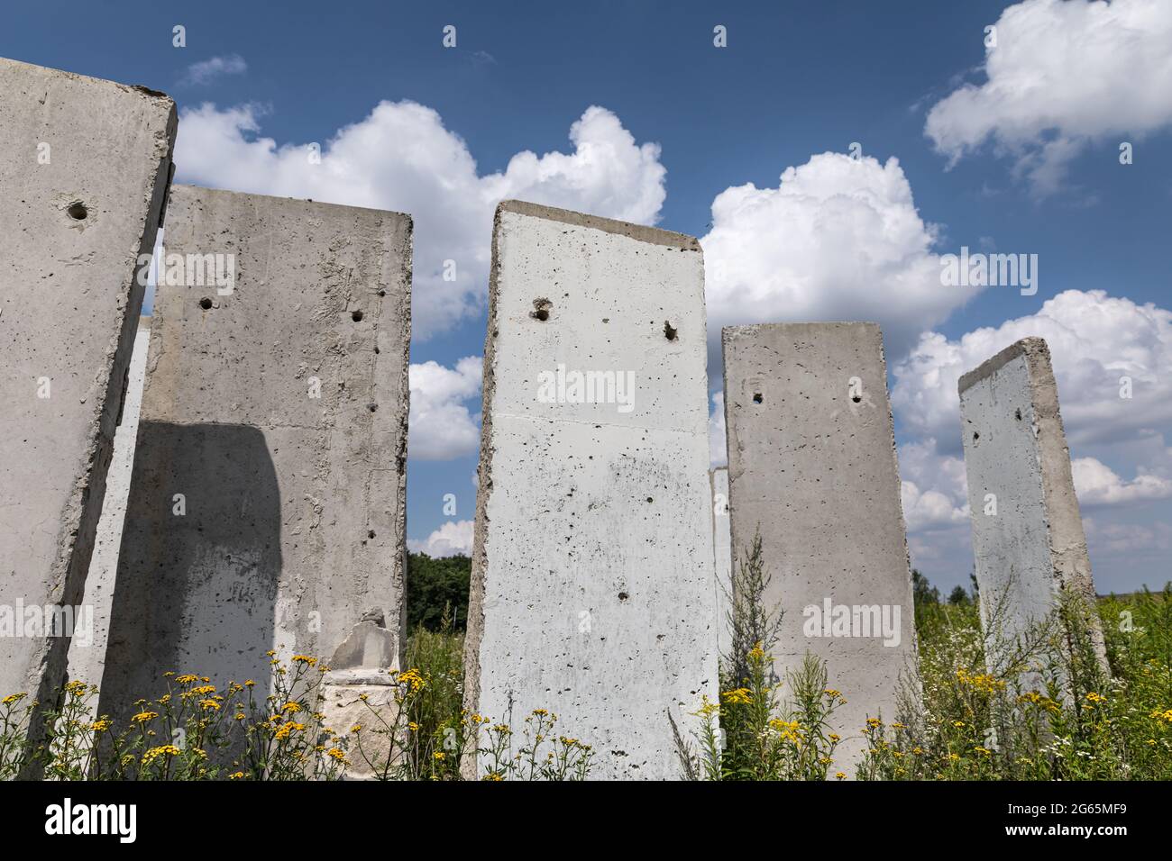 Old concrete slabs standing on a summer sunny day in the field. Old ...
