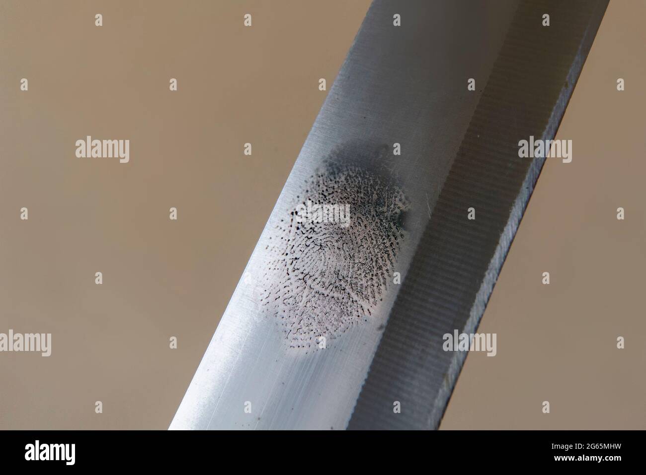 robber left his finger print on a metal surface after doing a crime ...