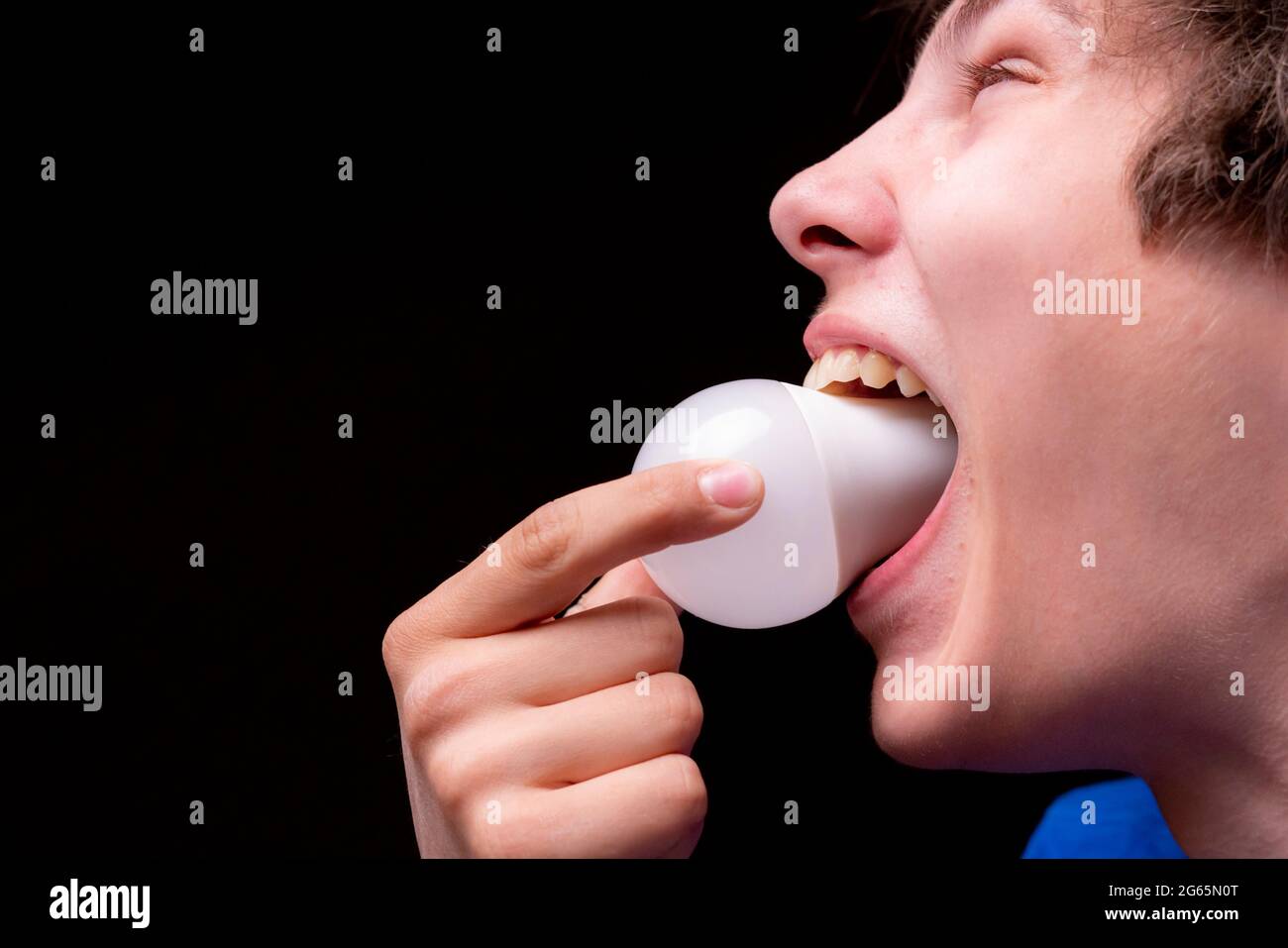 funny young man eat light bulb, joke concept, funny guy Stock Photo - Alamy