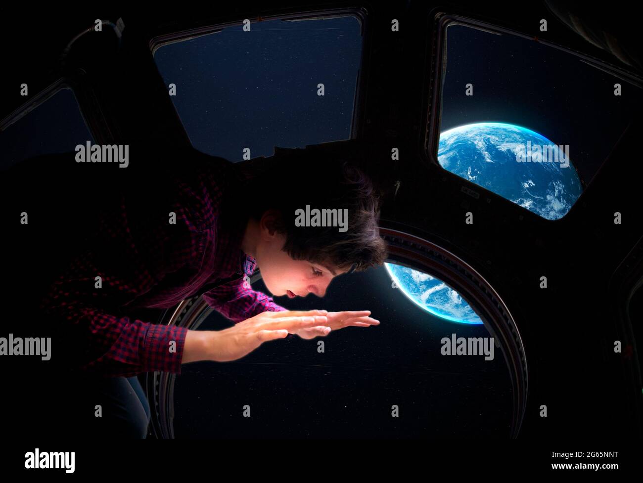 young space tourist in front of the space shuttles window. elements of ...