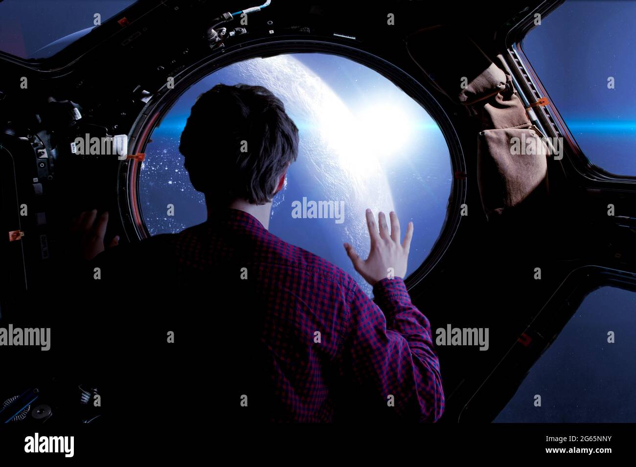 young space tourist in front of the space shuttles window. elements of ...