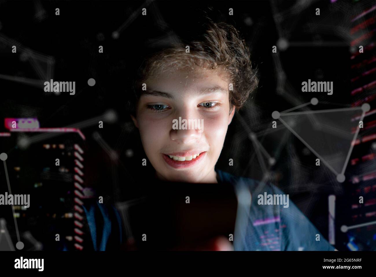 young attractive man use mobile phone late at night in a dark room ...