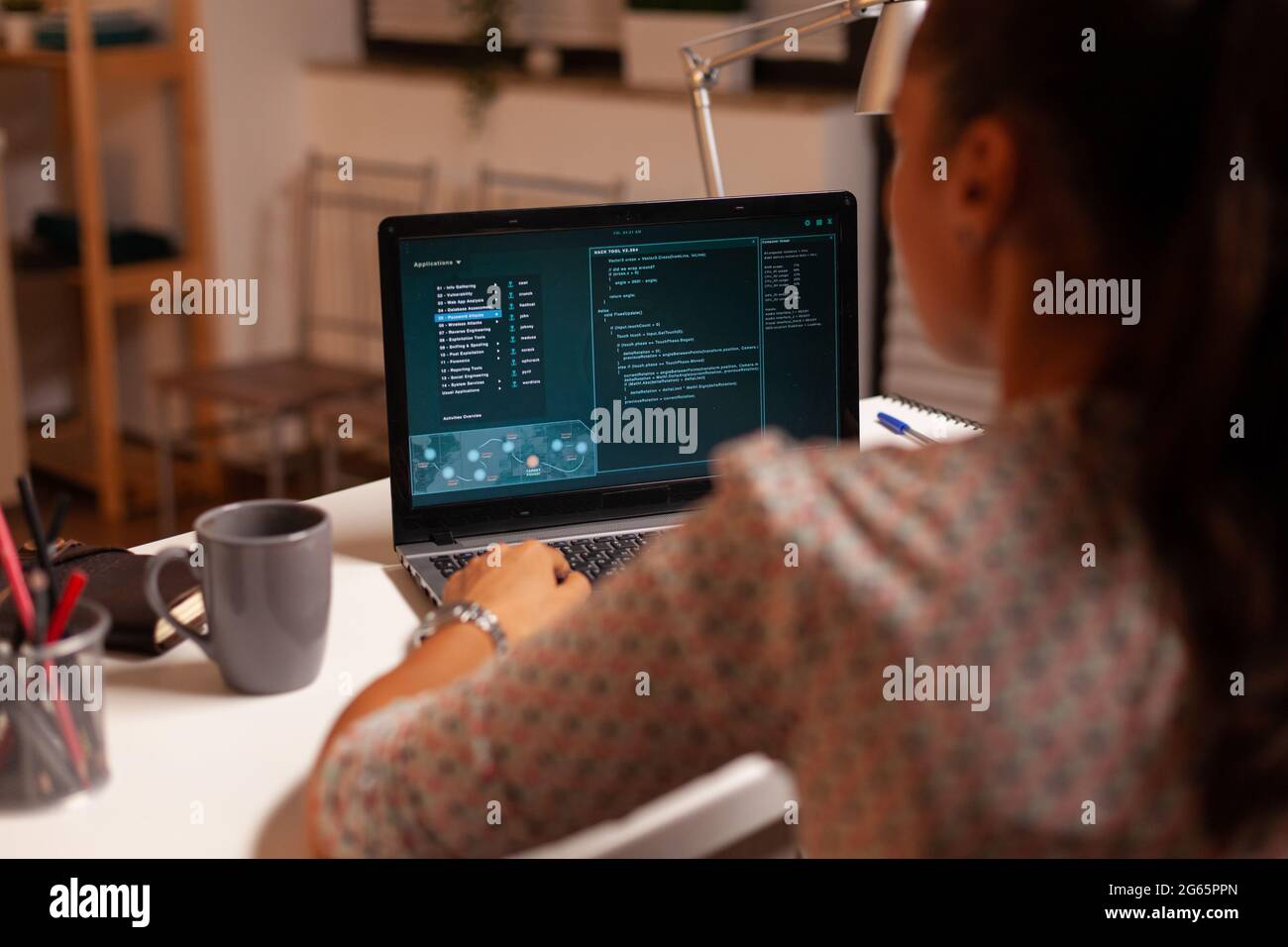 Female hacker sitting in front of computer and thinking how to fraud ...