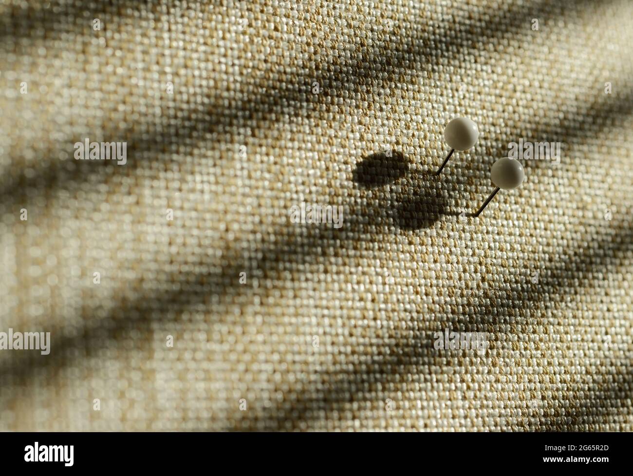 two pins in a fabric pinwall in the sun Stock Photo - Alamy