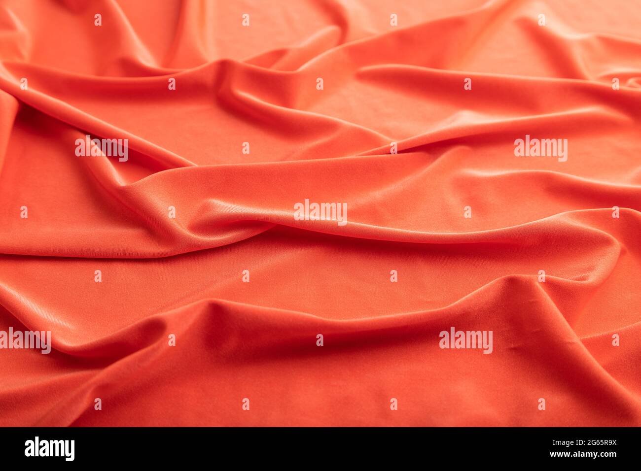 Fragment of red silk tissue. Side view, natural textile background and ...