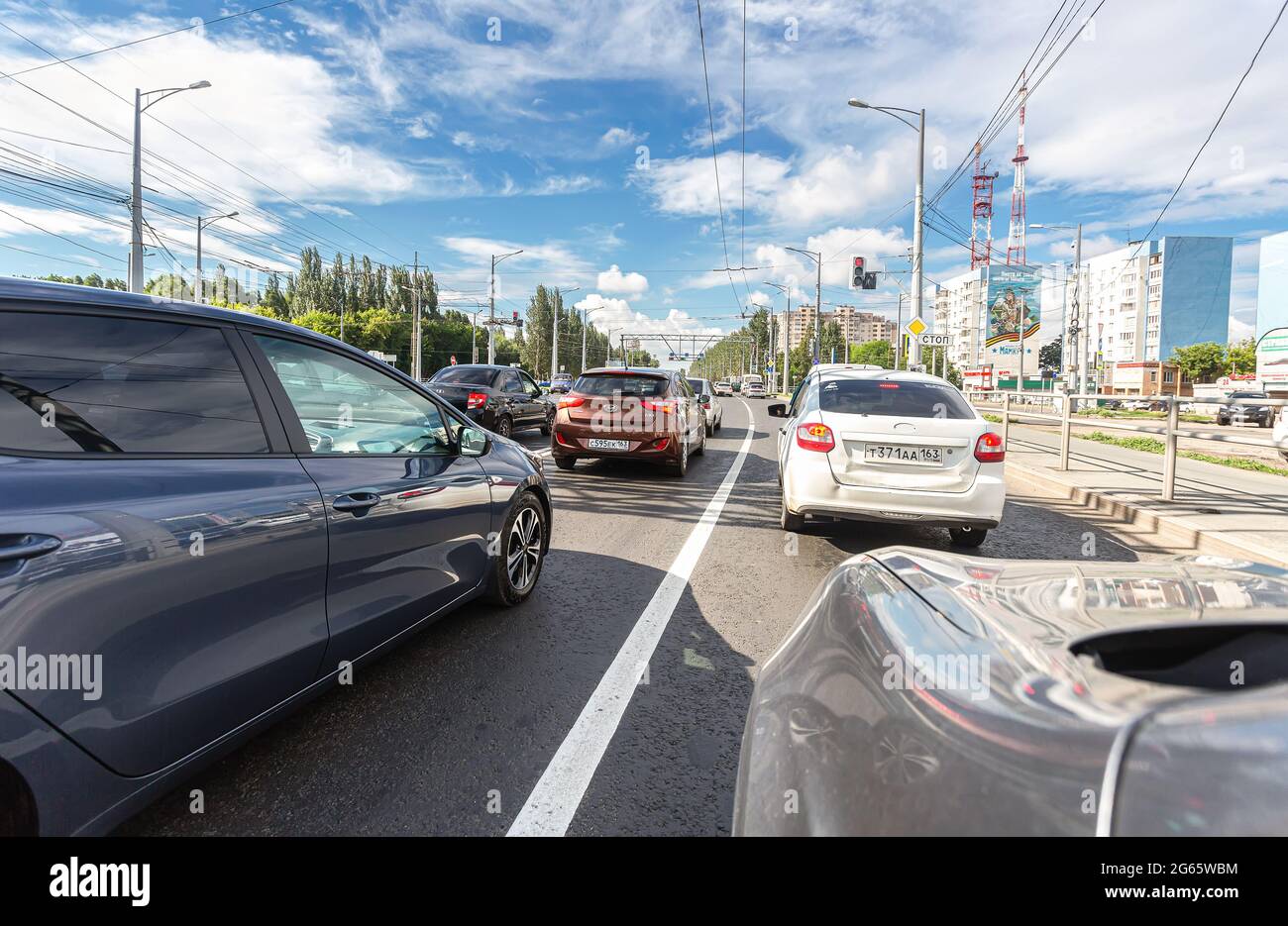 Samara, Russia - July 2, 2021: Cars drive along city street with multi ...