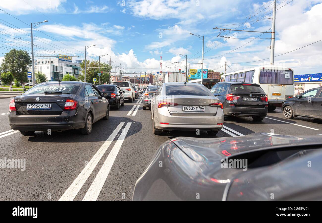 Samara, Russia - July 2, 2021: Cars drive along city street with multi ...