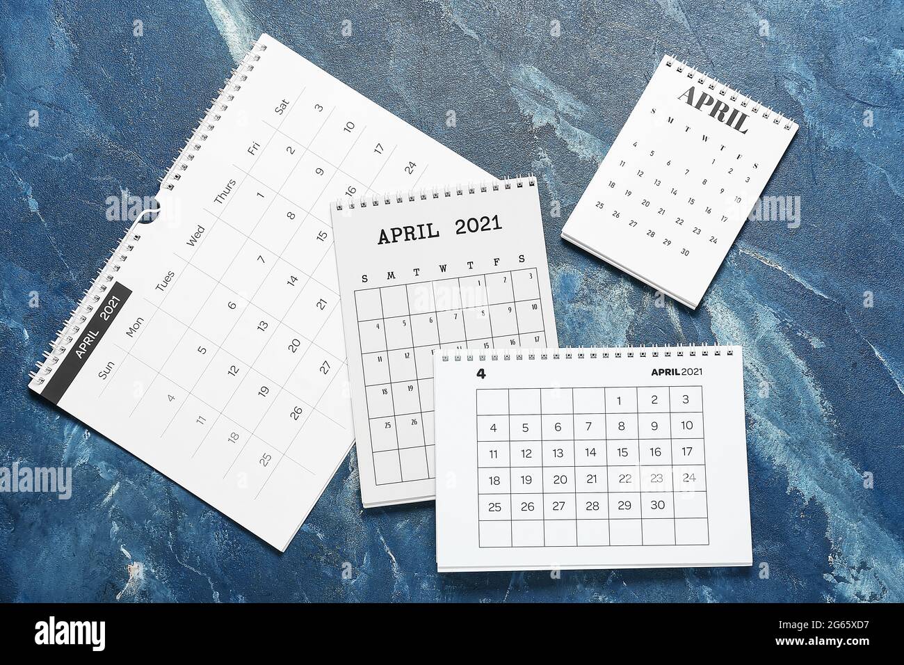 Flip paper calendars on color background Stock Photo - Alamy
