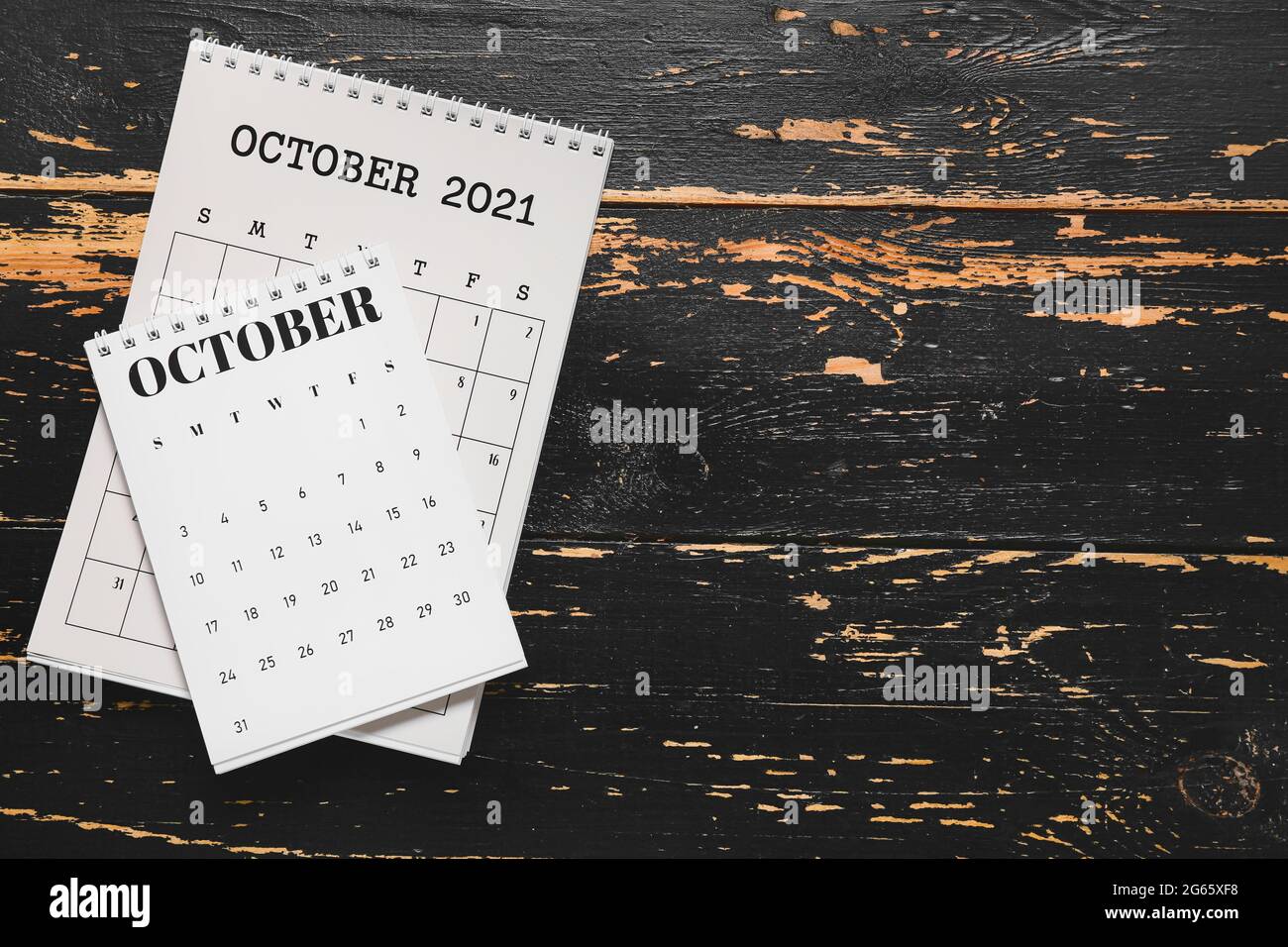 Flip paper calendars on dark wooden background Stock Photo - Alamy