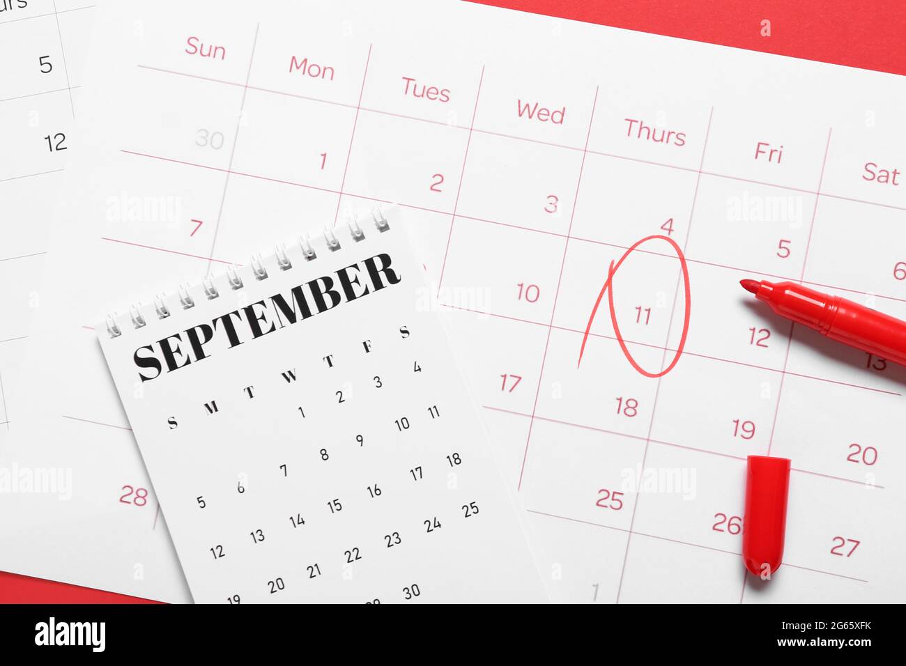 Calendars with marked date and marker on color background, closeup ...