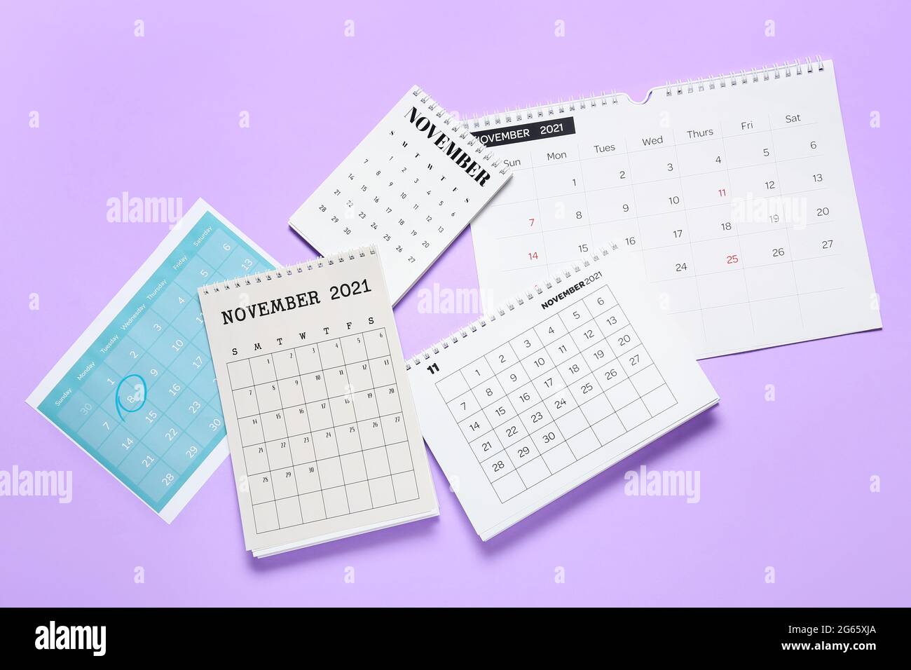 Different calendars on color background Stock Photo - Alamy