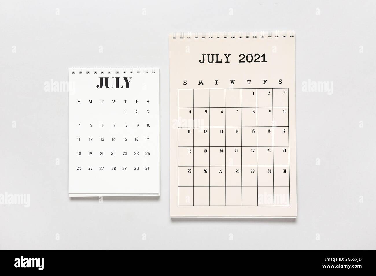 Flip paper calendars on light background Stock Photo - Alamy