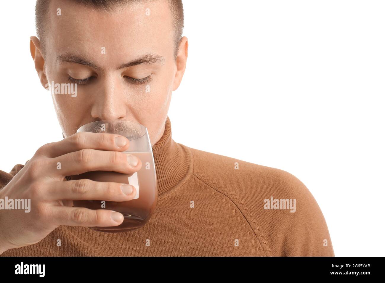 Handsome man drinking hot cocoa on white background Stock Photo - Alamy