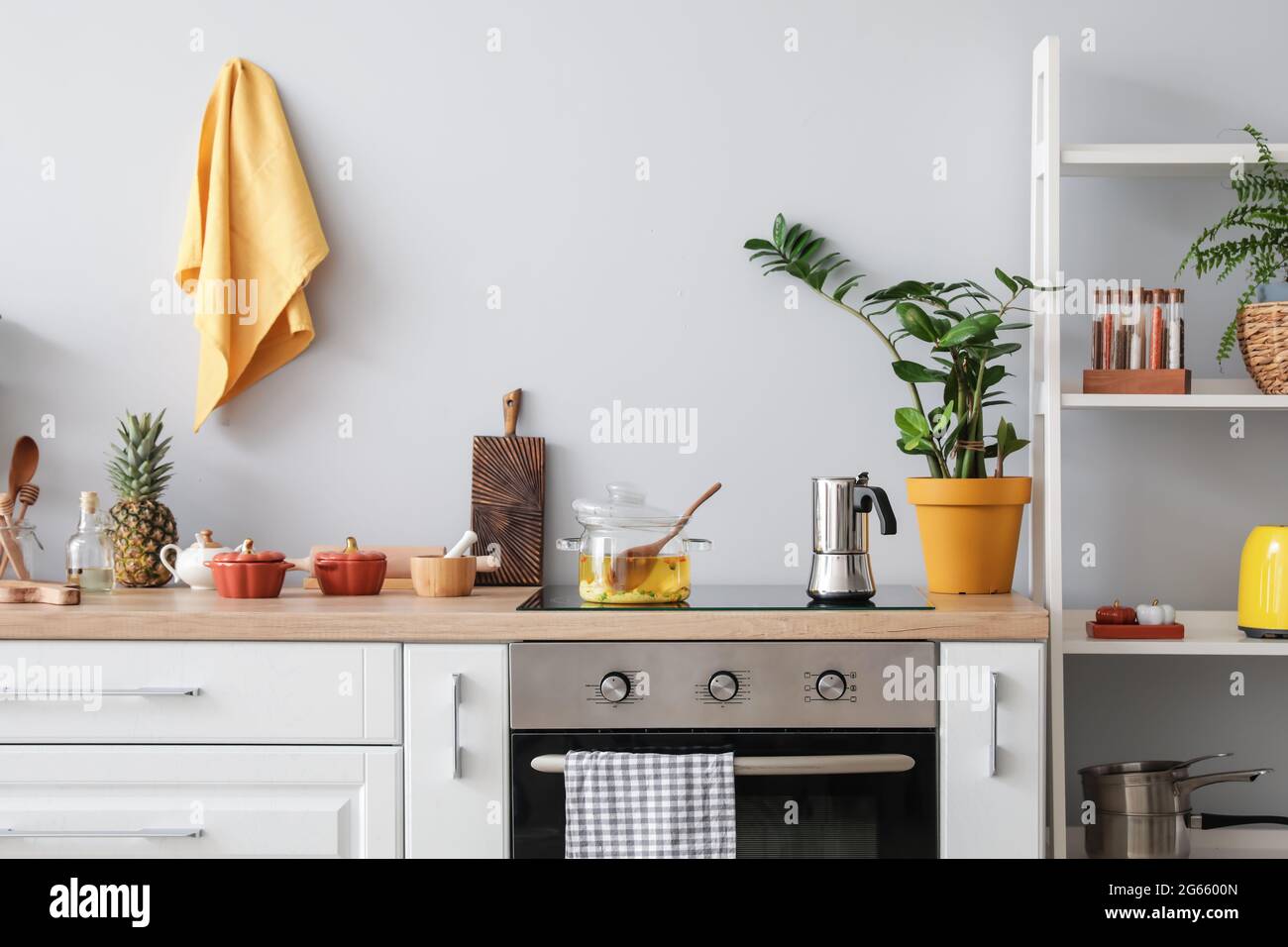 Modern electric stove and utensils in kitchen Stock Photo - Alamy