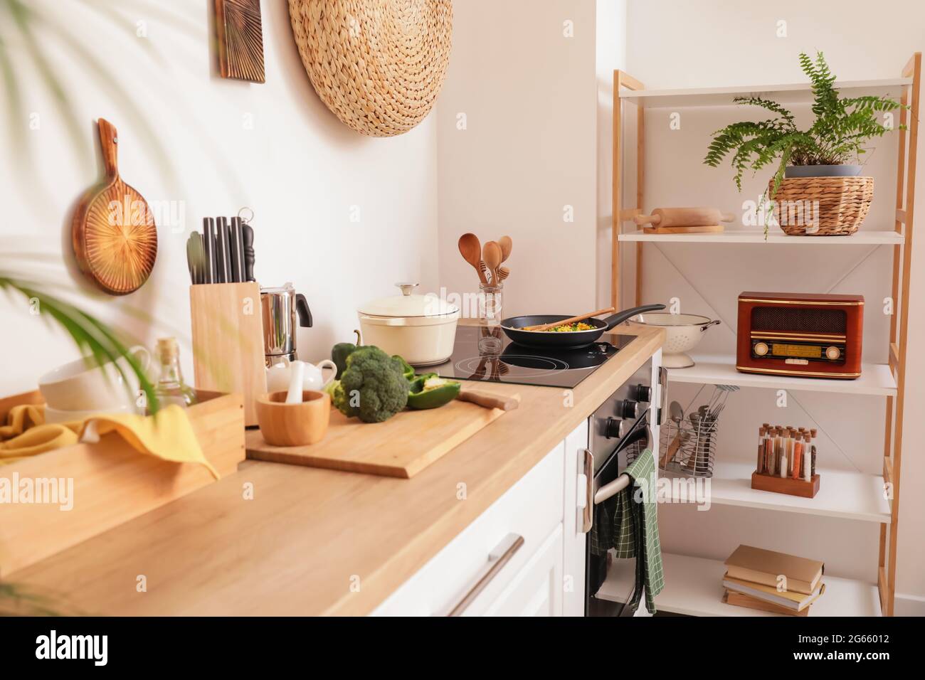 Modern electric stove and utensils in kitchen Stock Photo - Alamy