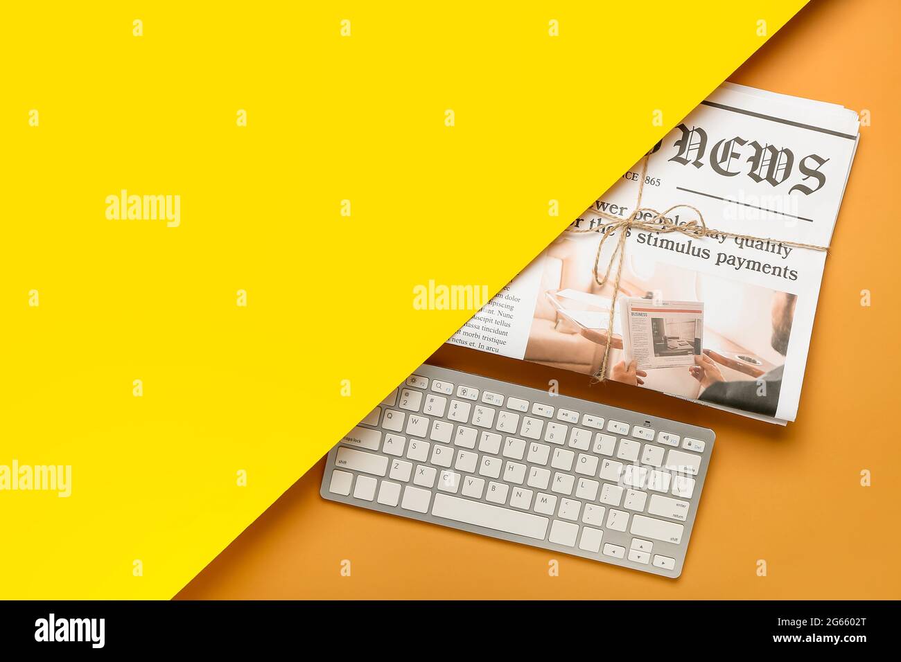Newspaper and computer keyboard on color background Stock Photo - Alamy