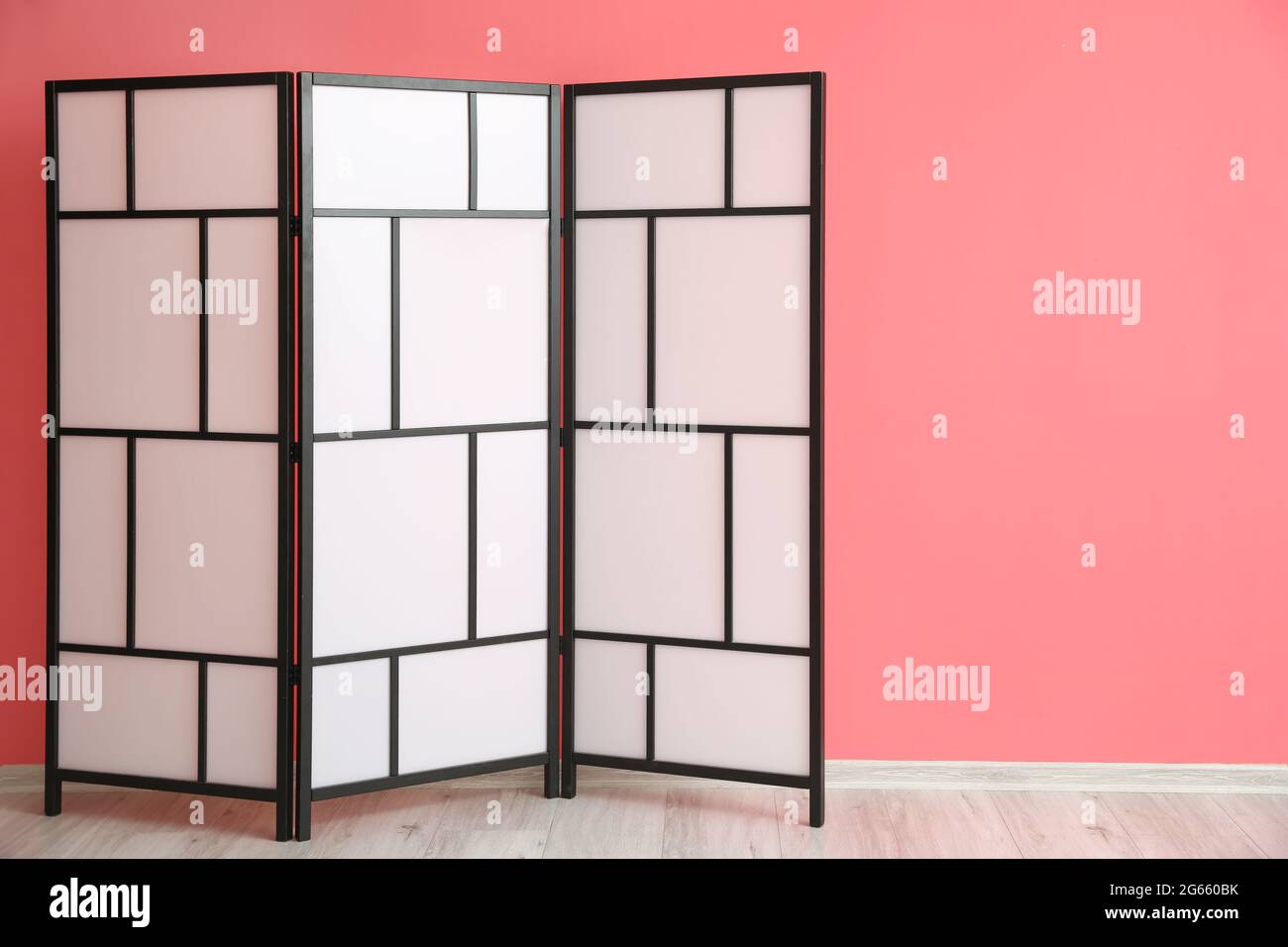 Modern folding screen near color wall Stock Photo - Alamy