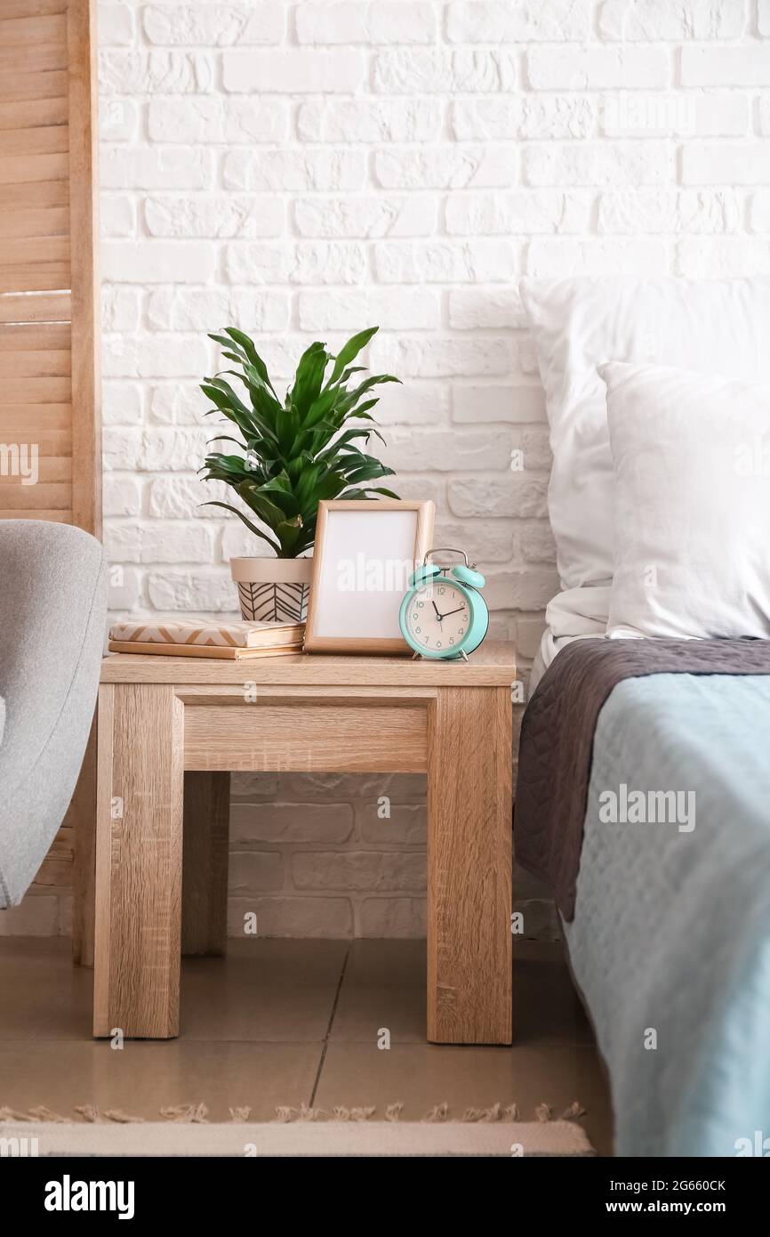 Interior of stylish bedroom with alarm clock Stock Photo - Alamy