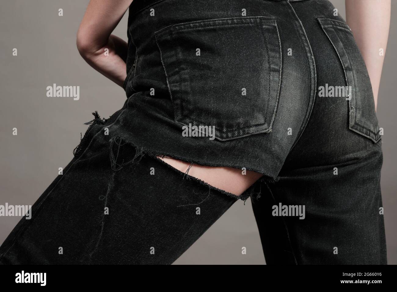 beautiful slim female back in ripped jeans close up Stock Photo - Alamy