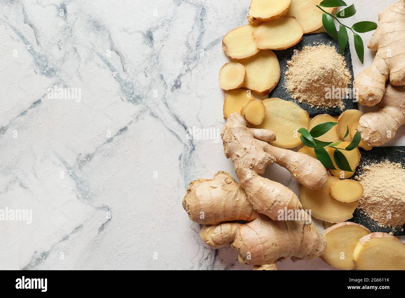 Heaps of ginger powder and roots on light background Stock Photo - Alamy