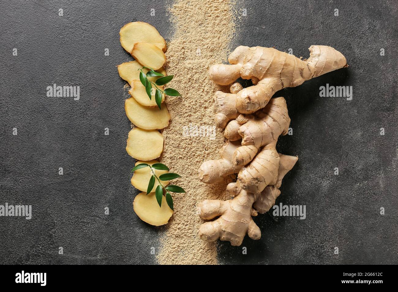 Fresh and ground ginger on dark background Stock Photo - Alamy