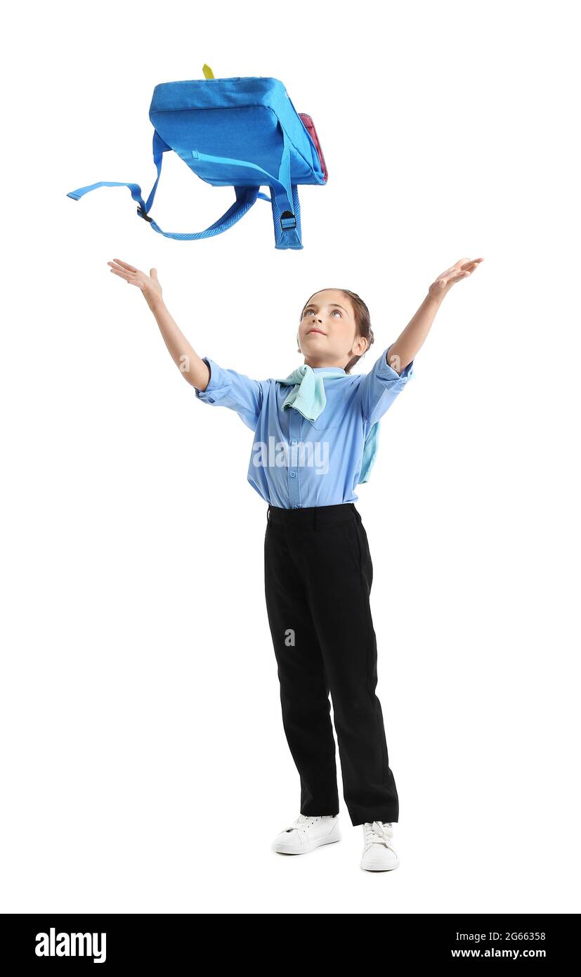 Cute little schoolgirl catching her backpack on white background Stock ...