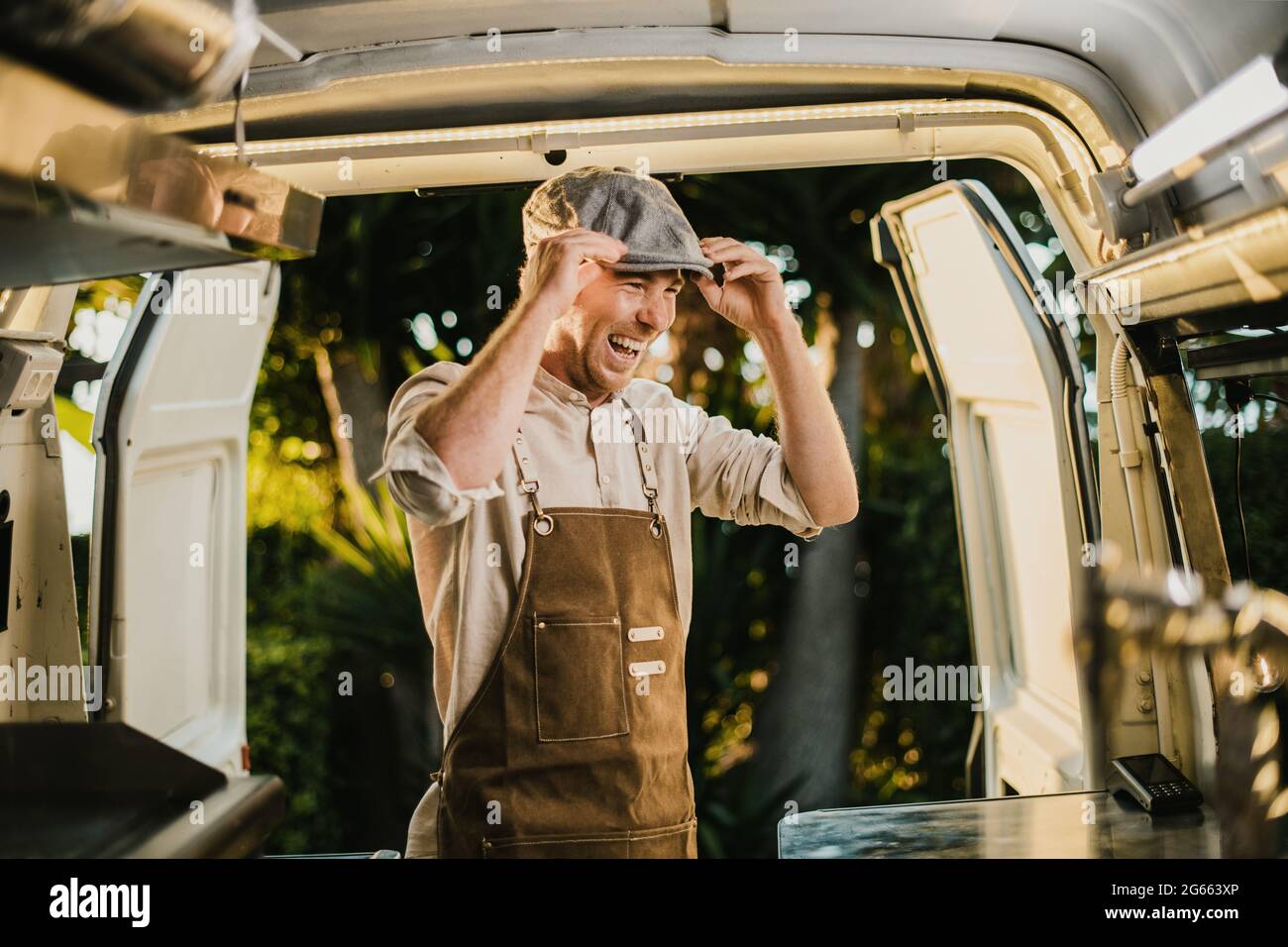 Happy chef having fun inside food truck restaurant - Focus on face ...