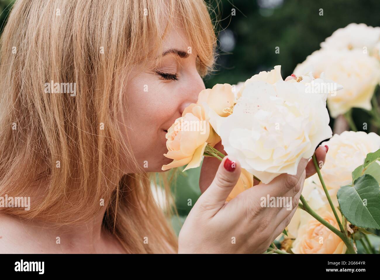 Spring and summer. young woman adorable blonde sniffing aroma of pink ...
