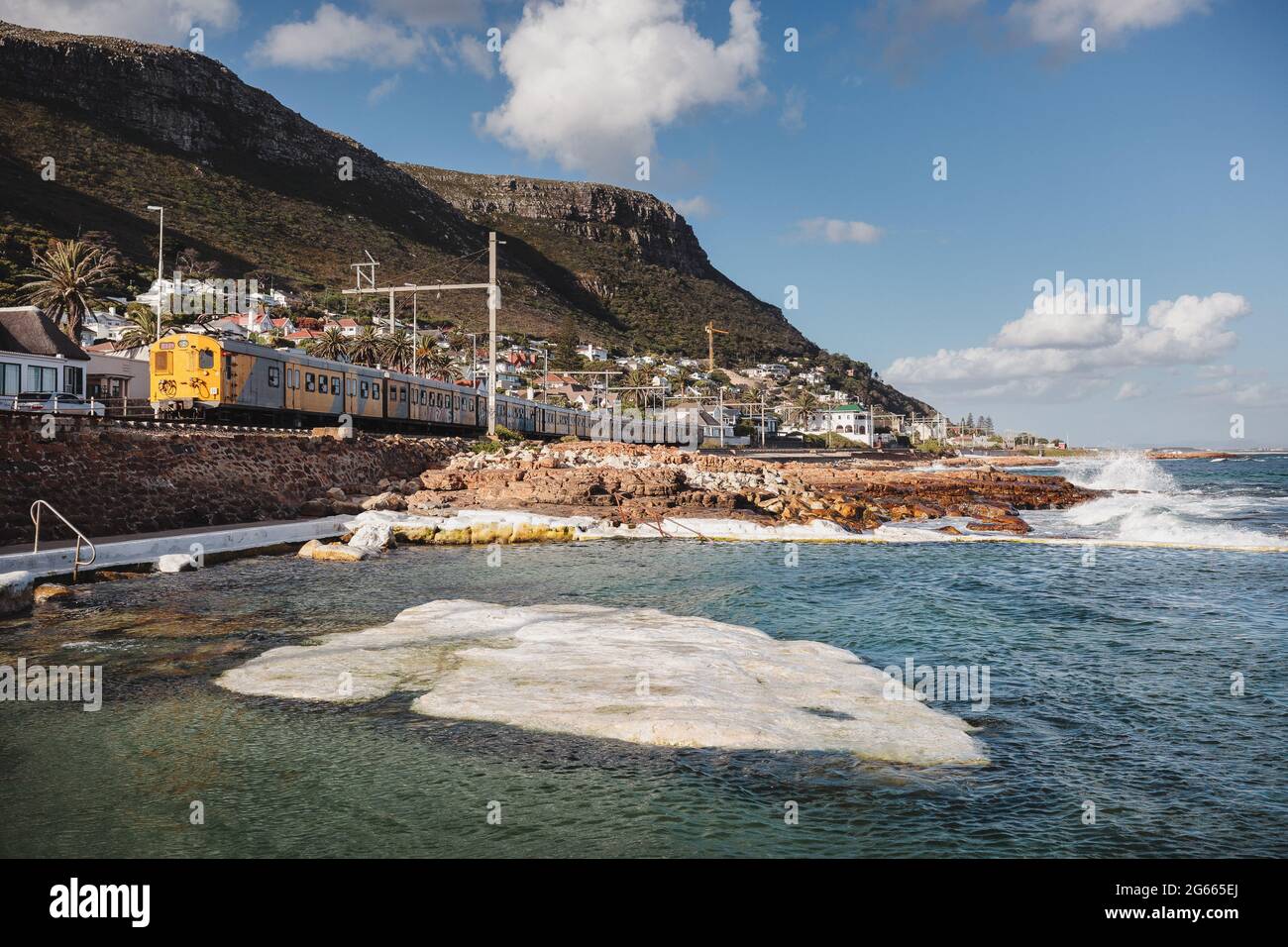 Suburban coastal train and tidal pool in Kalk Bay, Cape Town, South ...