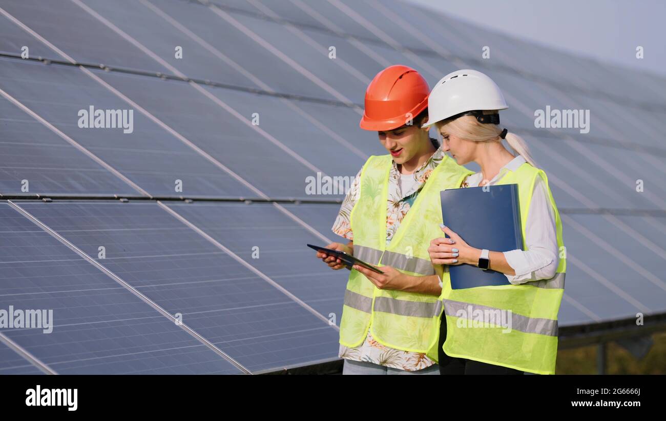 beautiful female engineer and young male trainee They are standing at a ...