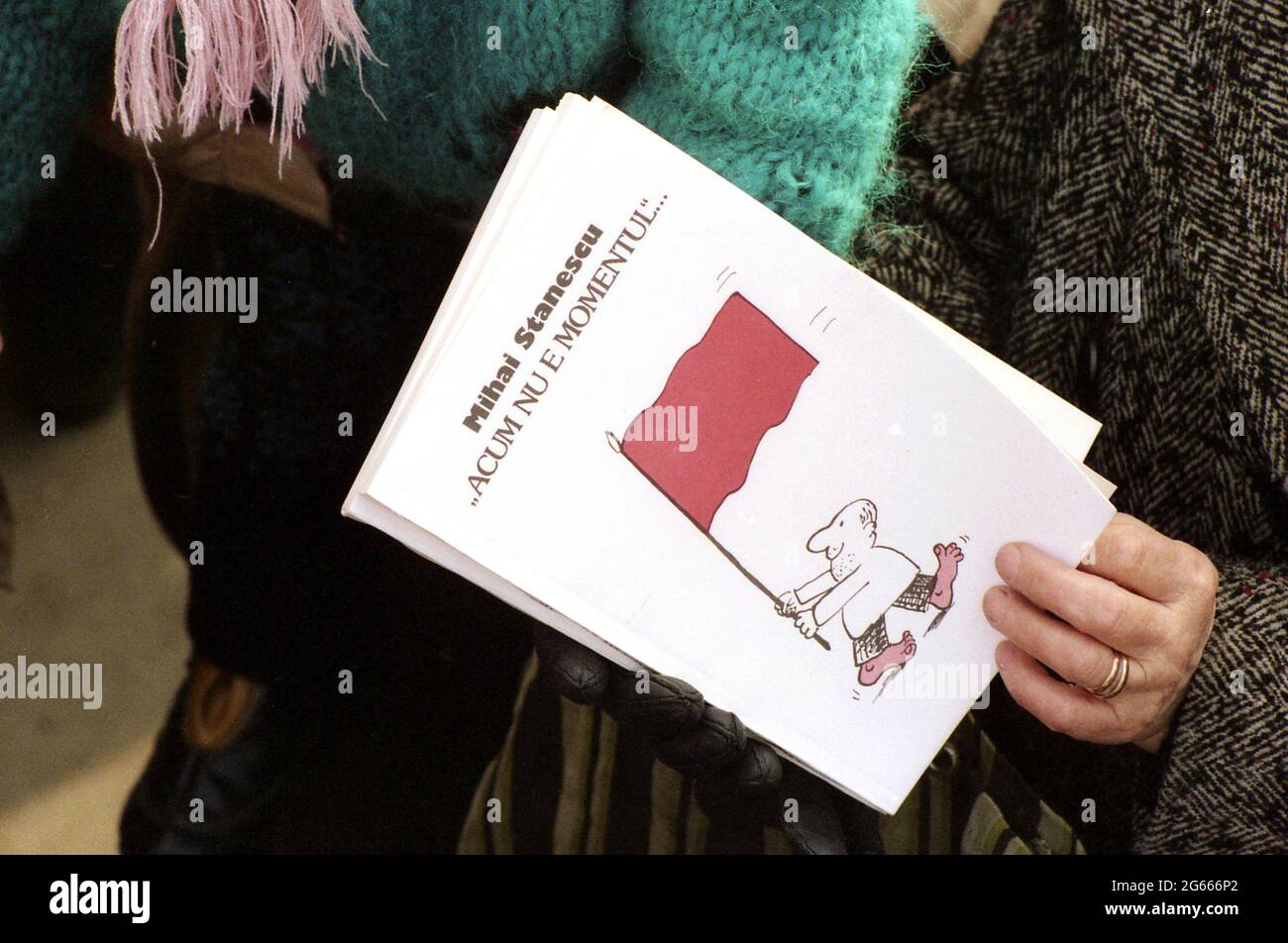 Bucharest, Romania, 1990. A person holds the anti-communist book " Acum ...