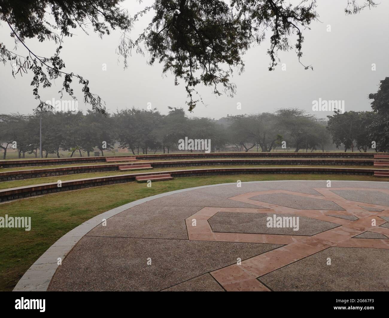 A large public amphitheatre in a park surrounded by trees Stock Photo ...