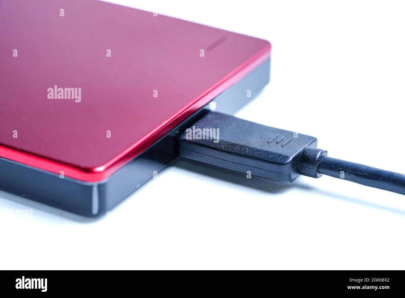 Red external hard disk isolated on white background Stock Photo - Alamy