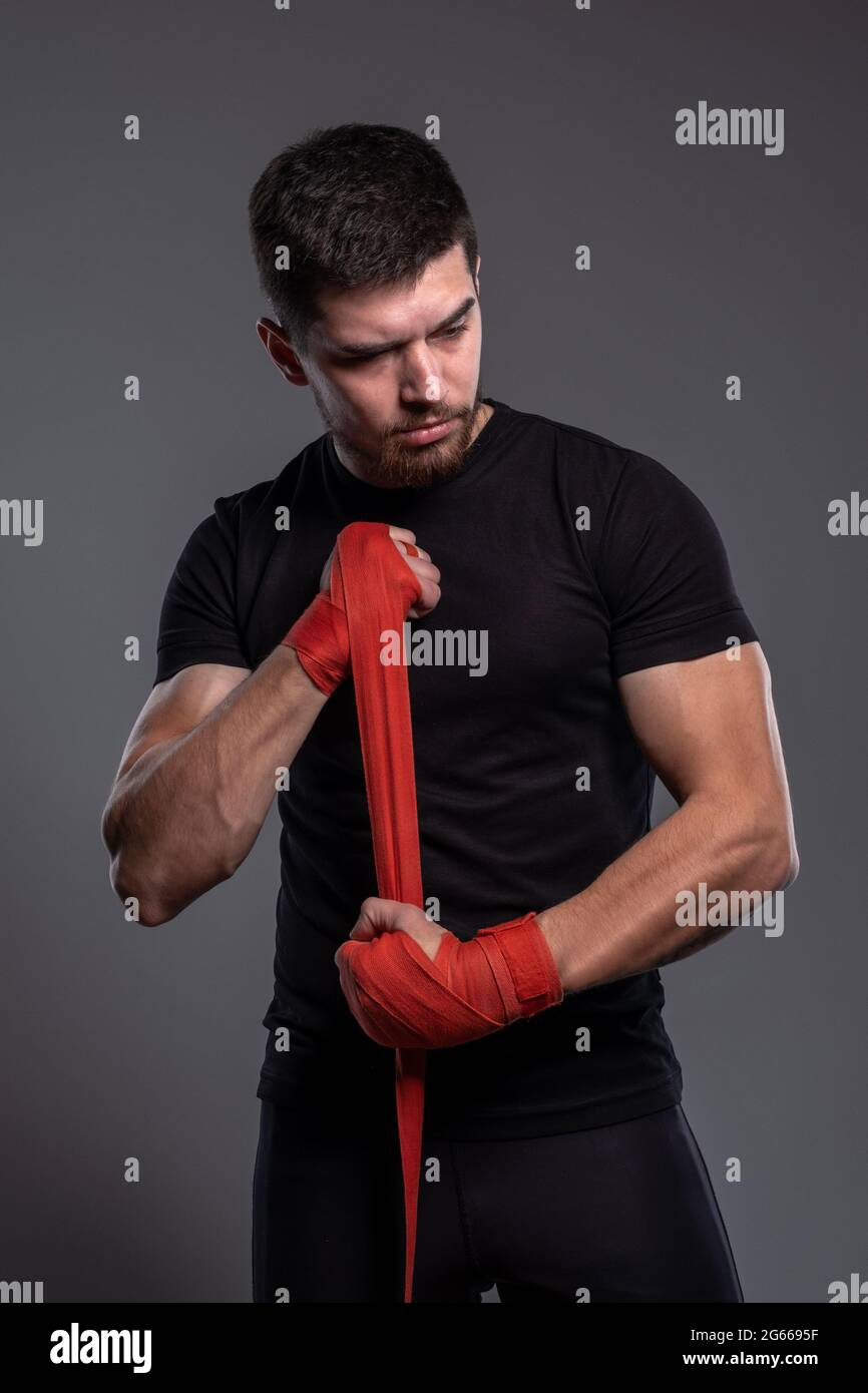 Young man wrapping hands with red boxing tape Stock Photo - Alamy
