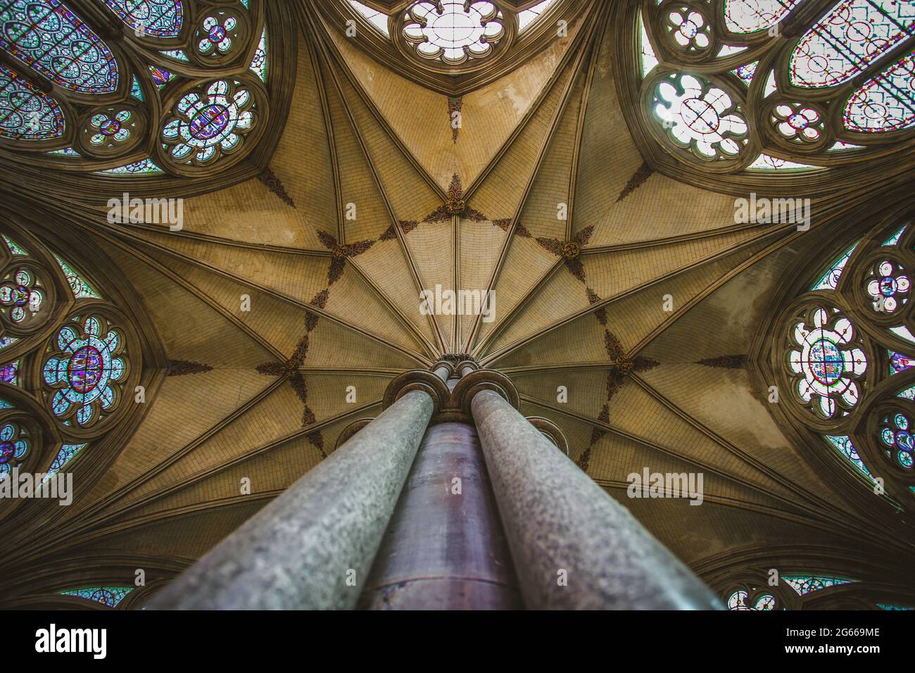 Low angle of an English church ceiling with a column in the center ...
