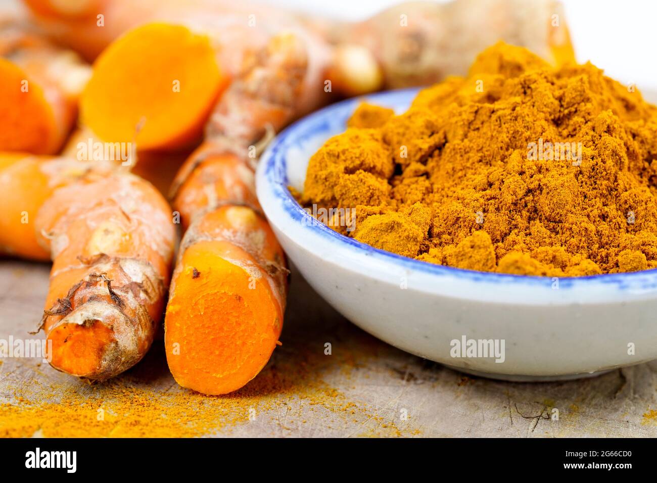 Turmeric roots and powder herb on wooden background Stock Photo - Alamy