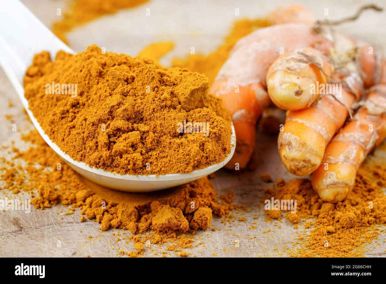 Turmeric roots and powder herb on wooden background Stock Photo - Alamy