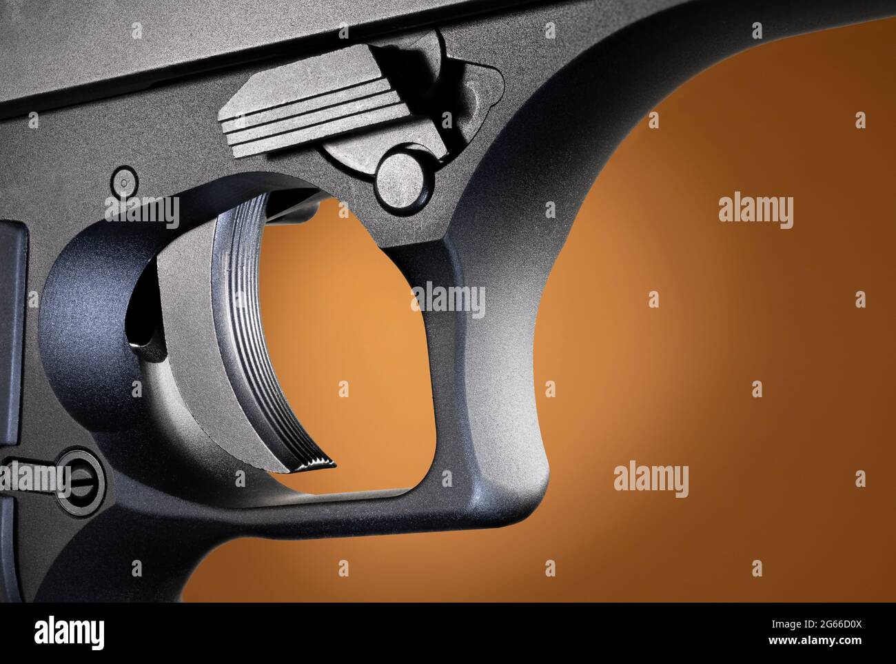 Metal trigger from a metal framed semi automatic handgun with a brown ...